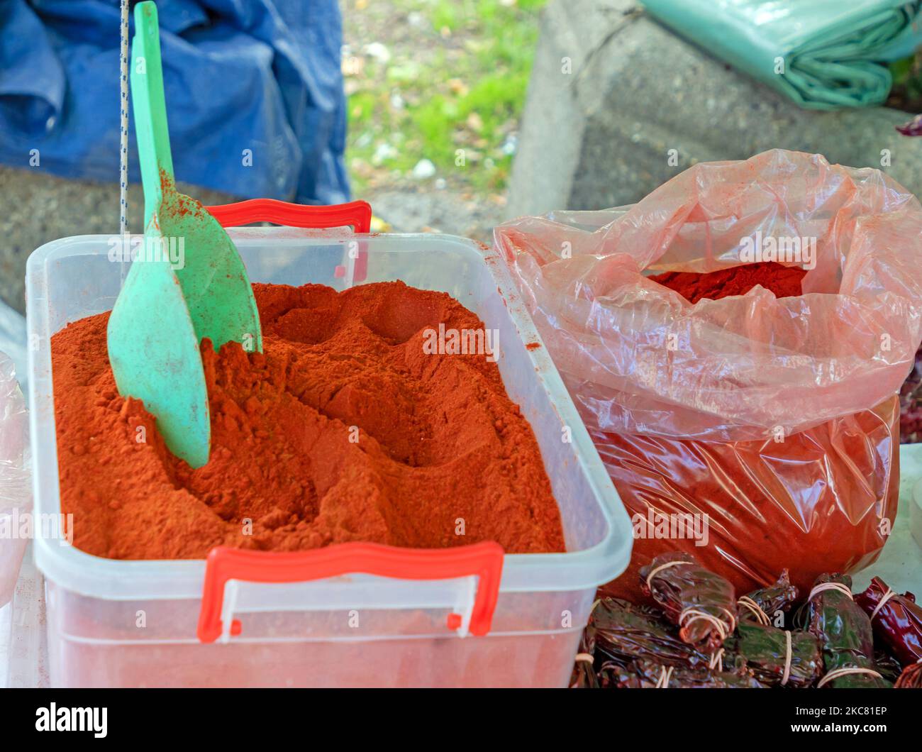 Hot grind red pepper in plastic box sold on market stall Stock Photo ...