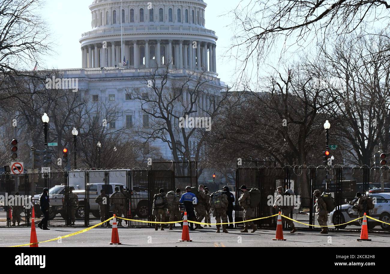 National Guard soldiers enter the razor wire topped protective fence ...
