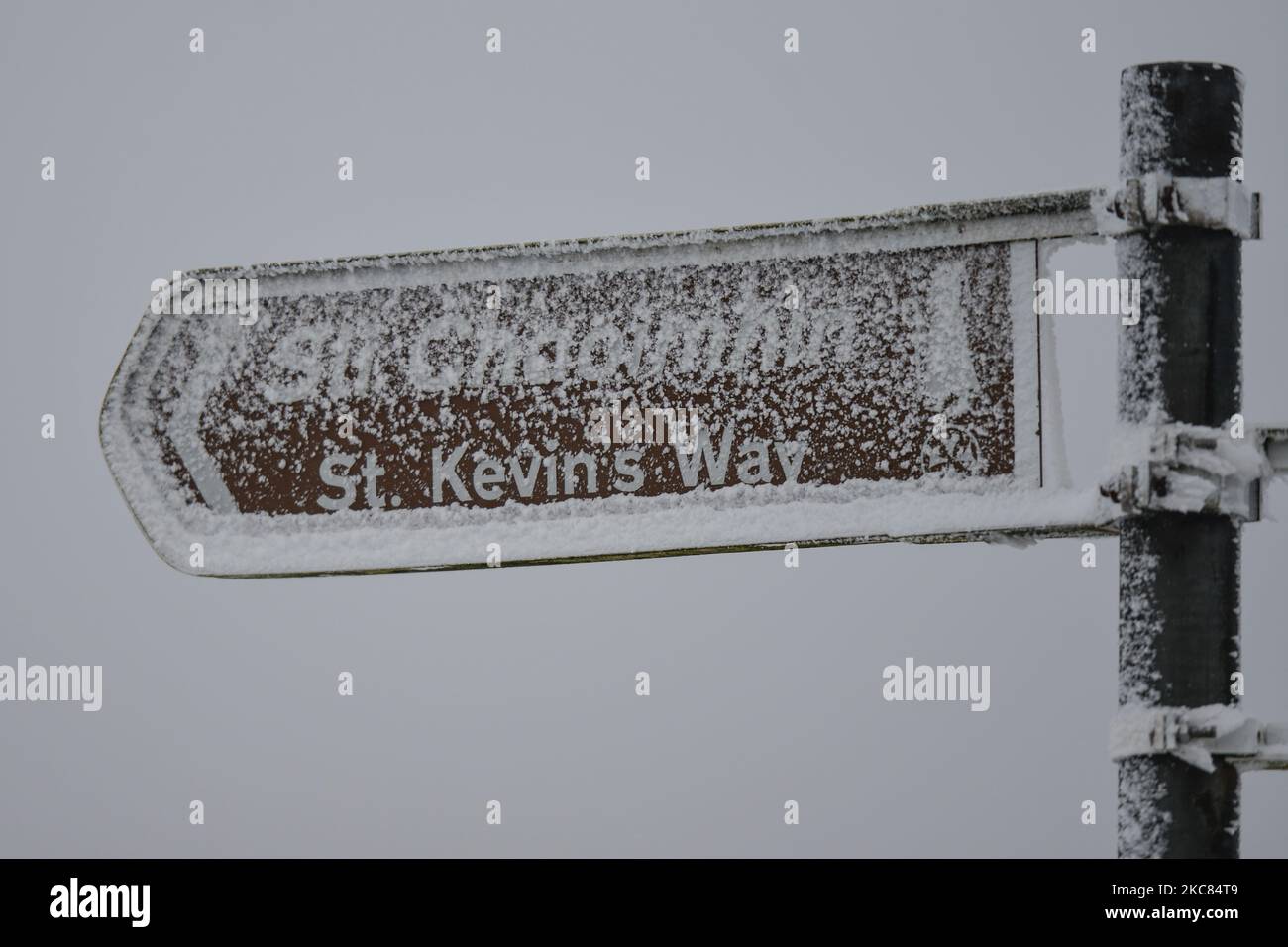 A sign 'St. Kevin's Way' partially covered with snow at Wicklow Gap, Co ...