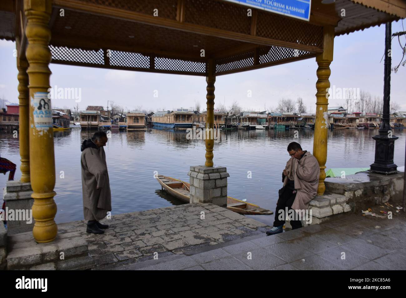 People sit on the bank of Dal Lake Srinagar, Indian Administered ...