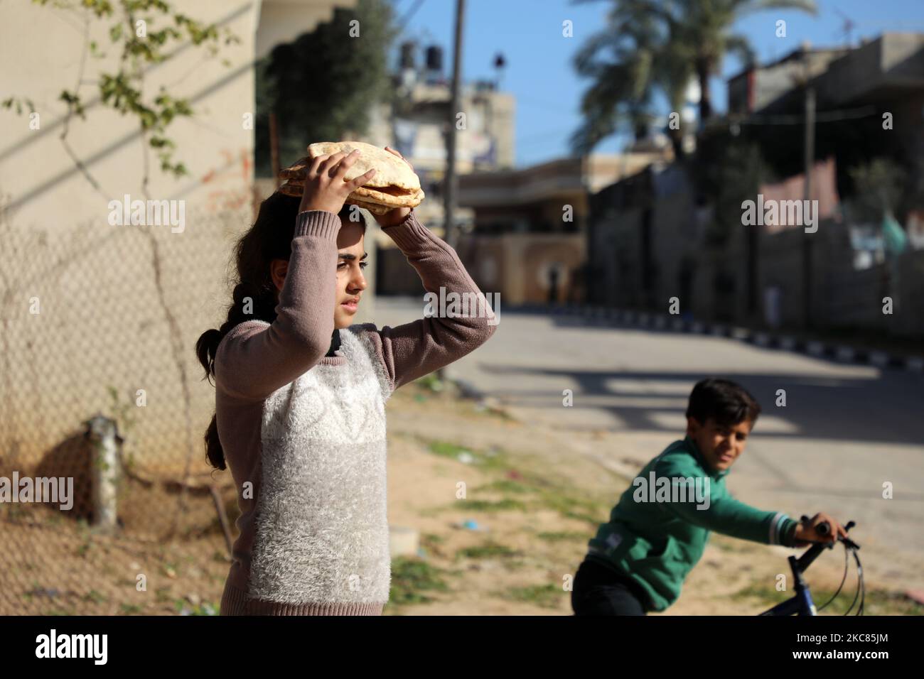A Palestinian girl carries bread in the northern Gaza Strip on January ...