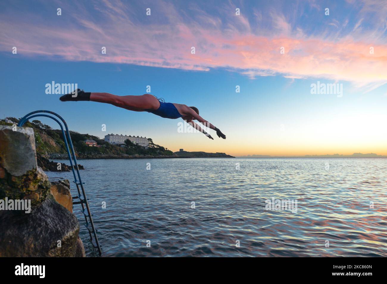 A swimmer jumps into the sea at the Vico bathing place, Hawk Cliff, in ...