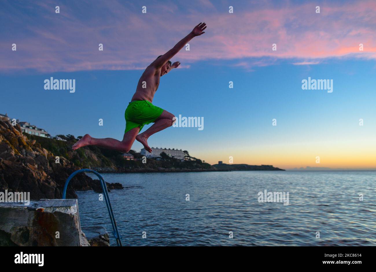 A swimmer jumps into the sea at the Vico bathing place, Hawk Cliff, in ...