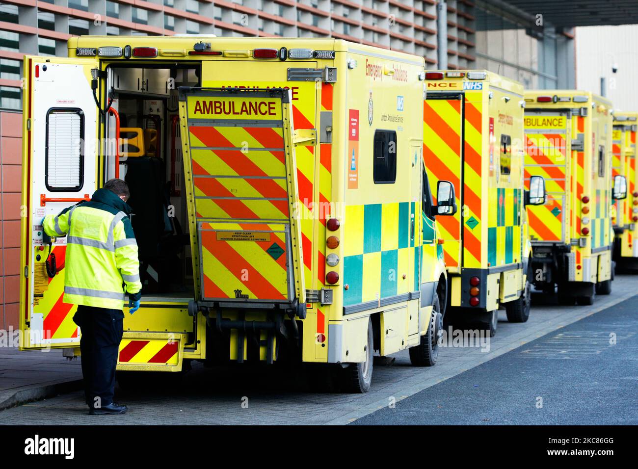 A paramedic lowers the loading platform of an ambulance outside the ...