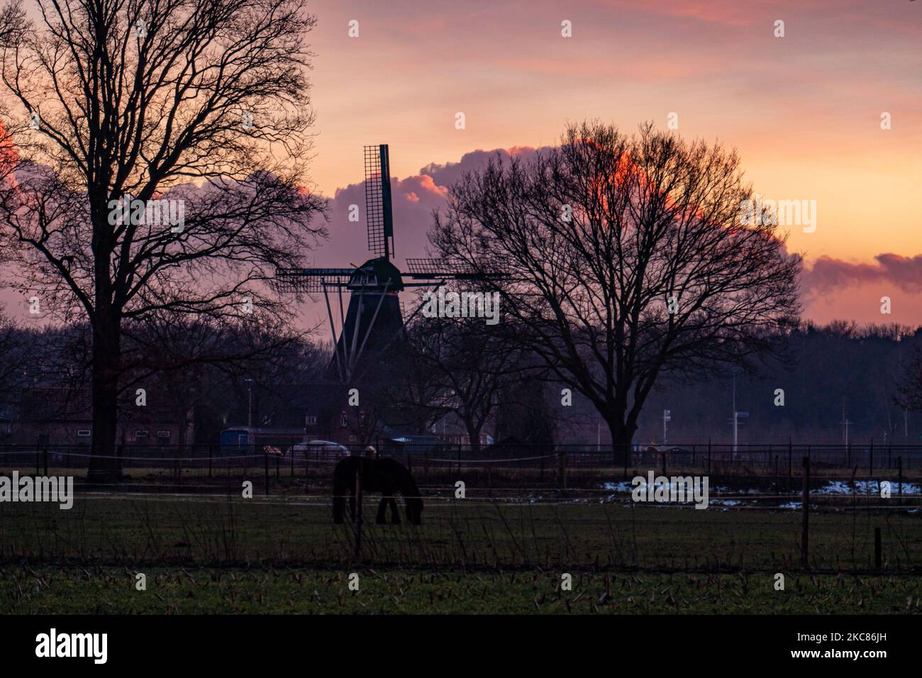 A traditional Dutch windmill as seen around sunset time at the sweet ...