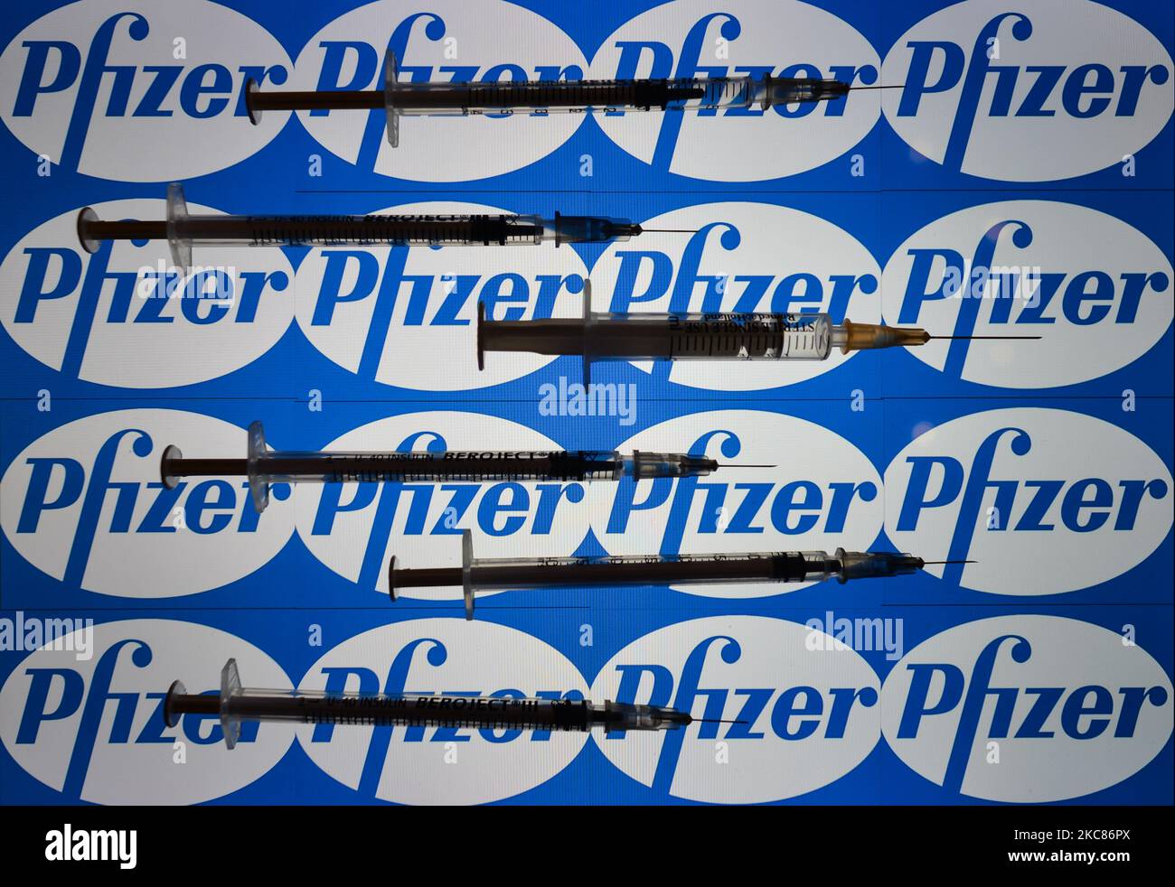 An illustrative image of medical syringes in front of a Pfizer logo ...