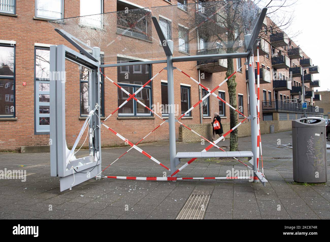 A damaged with broken glasses bus stop. The aftermath of the anti ...