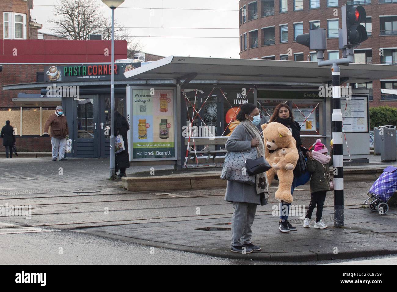 Damaged tram stop Randweg as seen with people wearing facemask. The ...