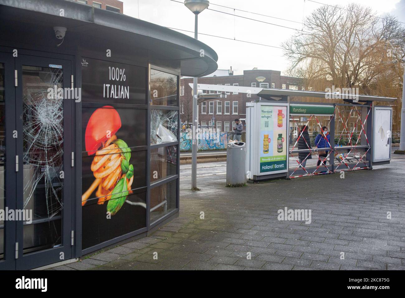 Damaged tram stop Randweg as seen with people wearing facemask. The ...