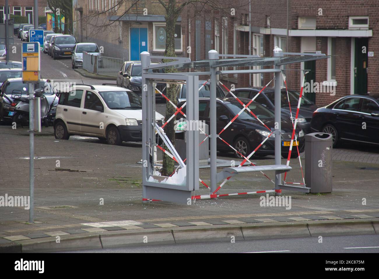A damaged with broken glasses bus stop. The aftermath of the anti ...