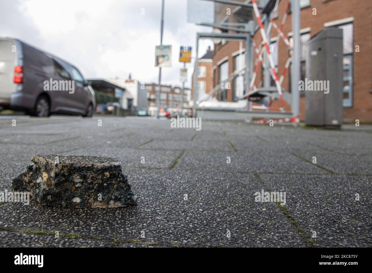 A stone that was thrown toward the bus stop that damaged it by breaking ...