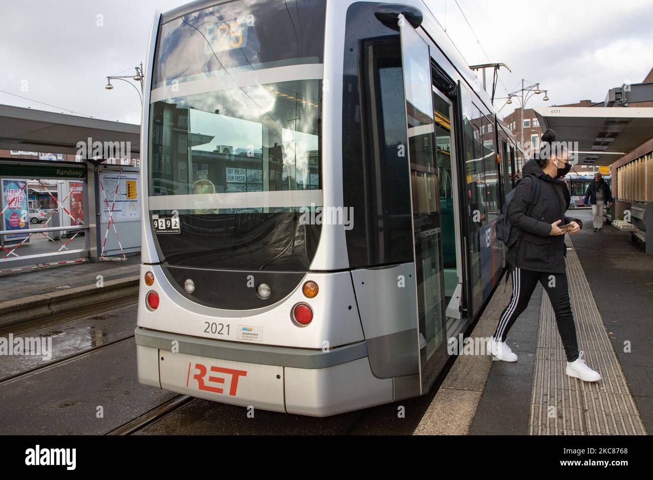 A young lady disembarks the tram, while the Randweg stop is seen ...