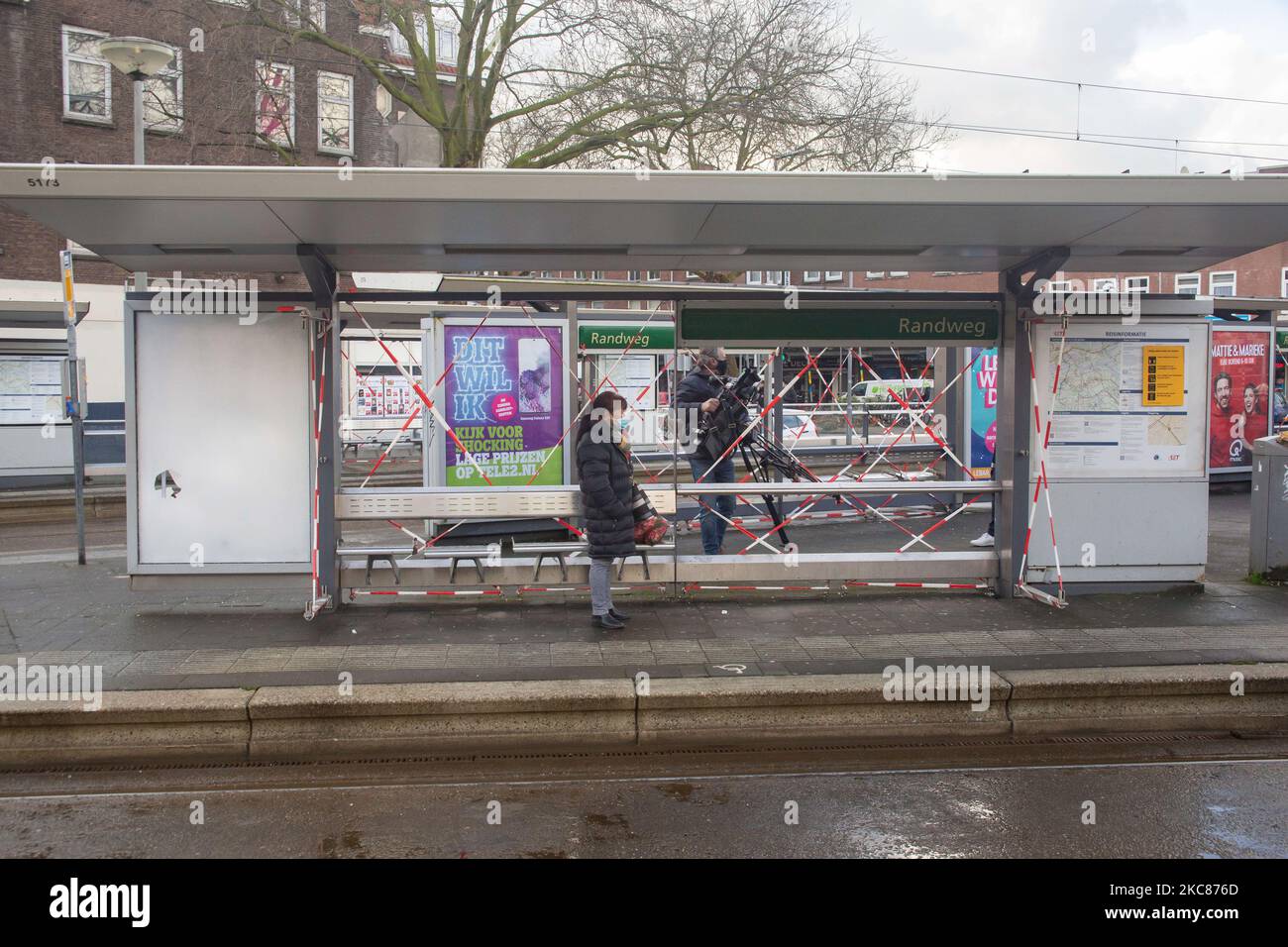 Damaged tram stop Randweg as seen with people wearing facemask. The ...
