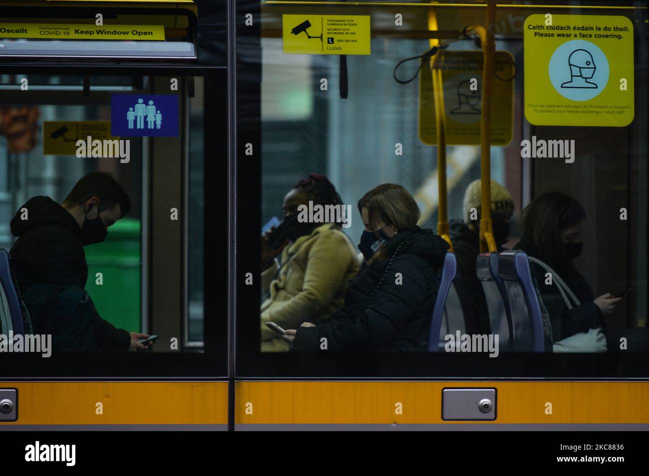 People wearing face masks seen inside a LUAS in Dublin city center ...
