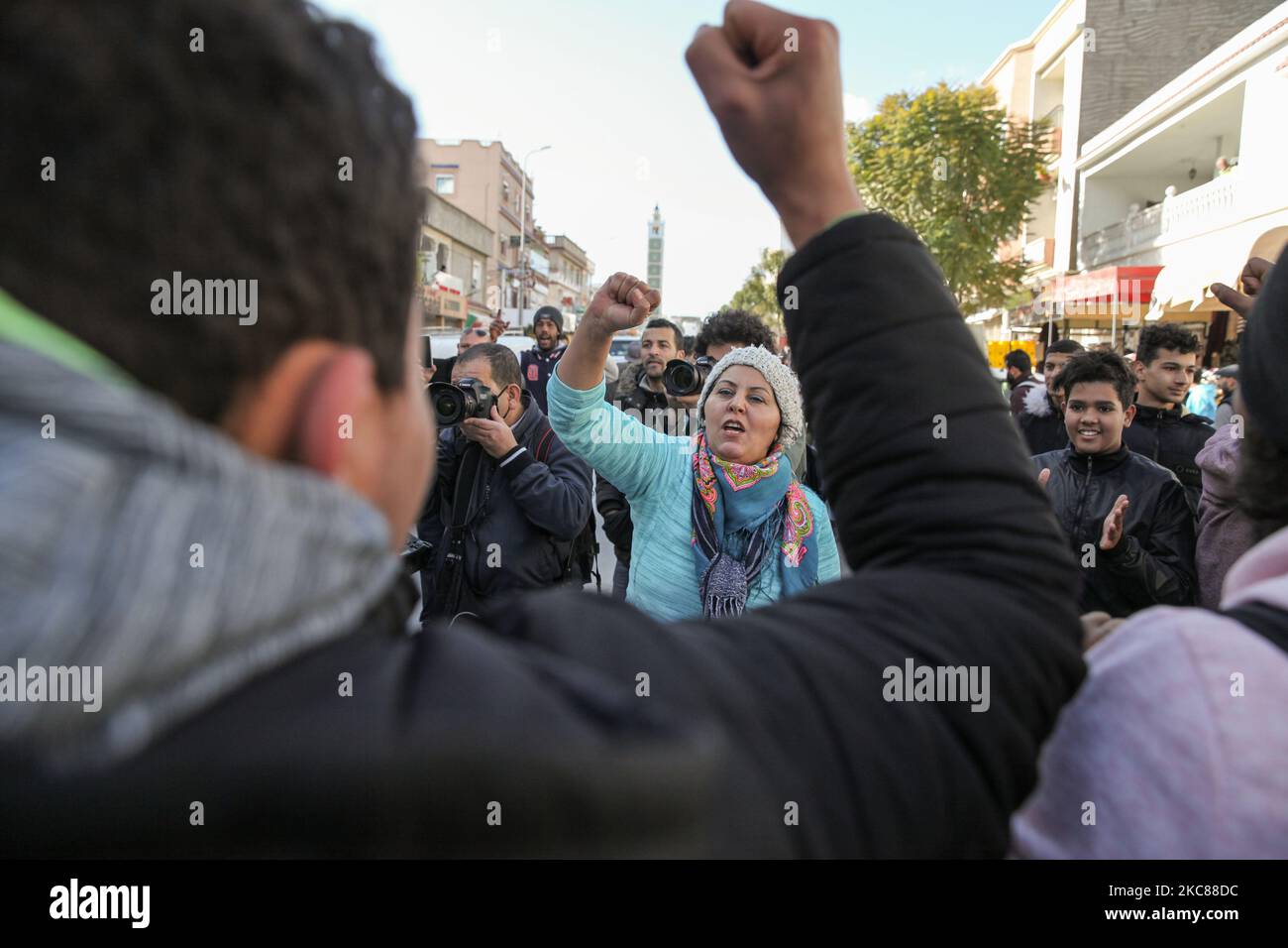 Protesters raise their fists as they shout anti government slogans ...