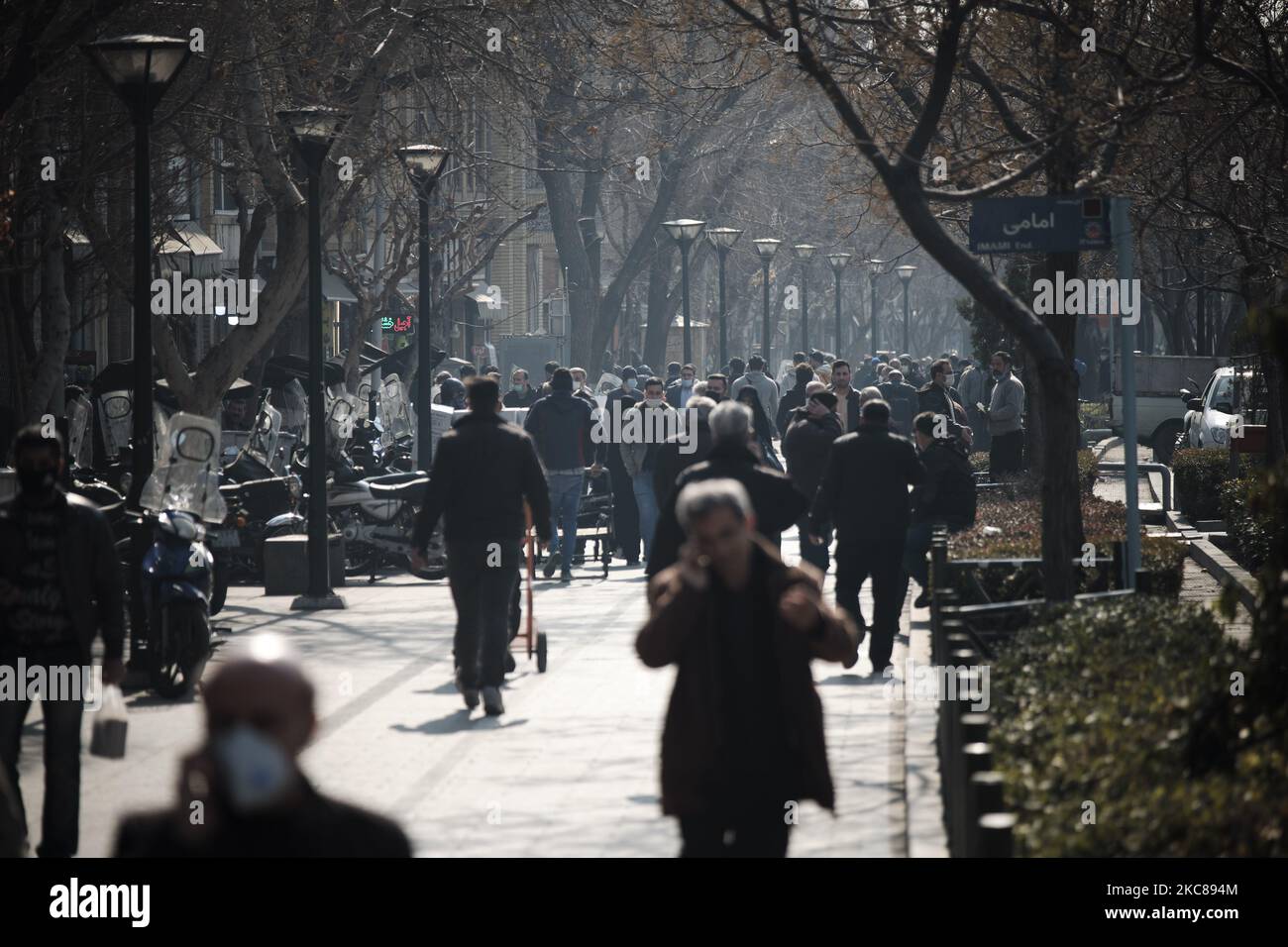 Iranian people walk along a street-side out of Tehran’s Traditional ...