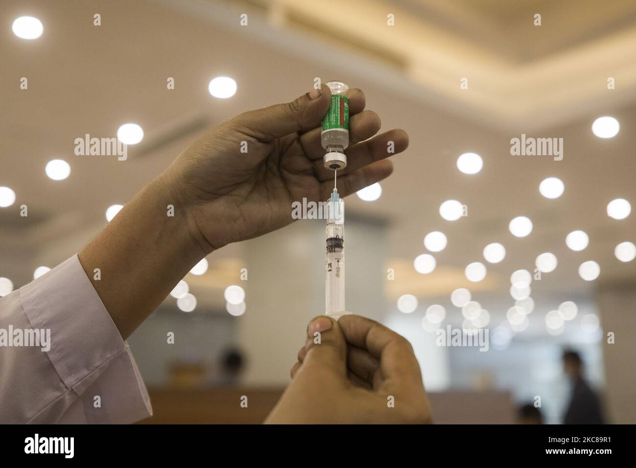 A close up of health worker preparing injection of Oxford-AstraZeneca ...