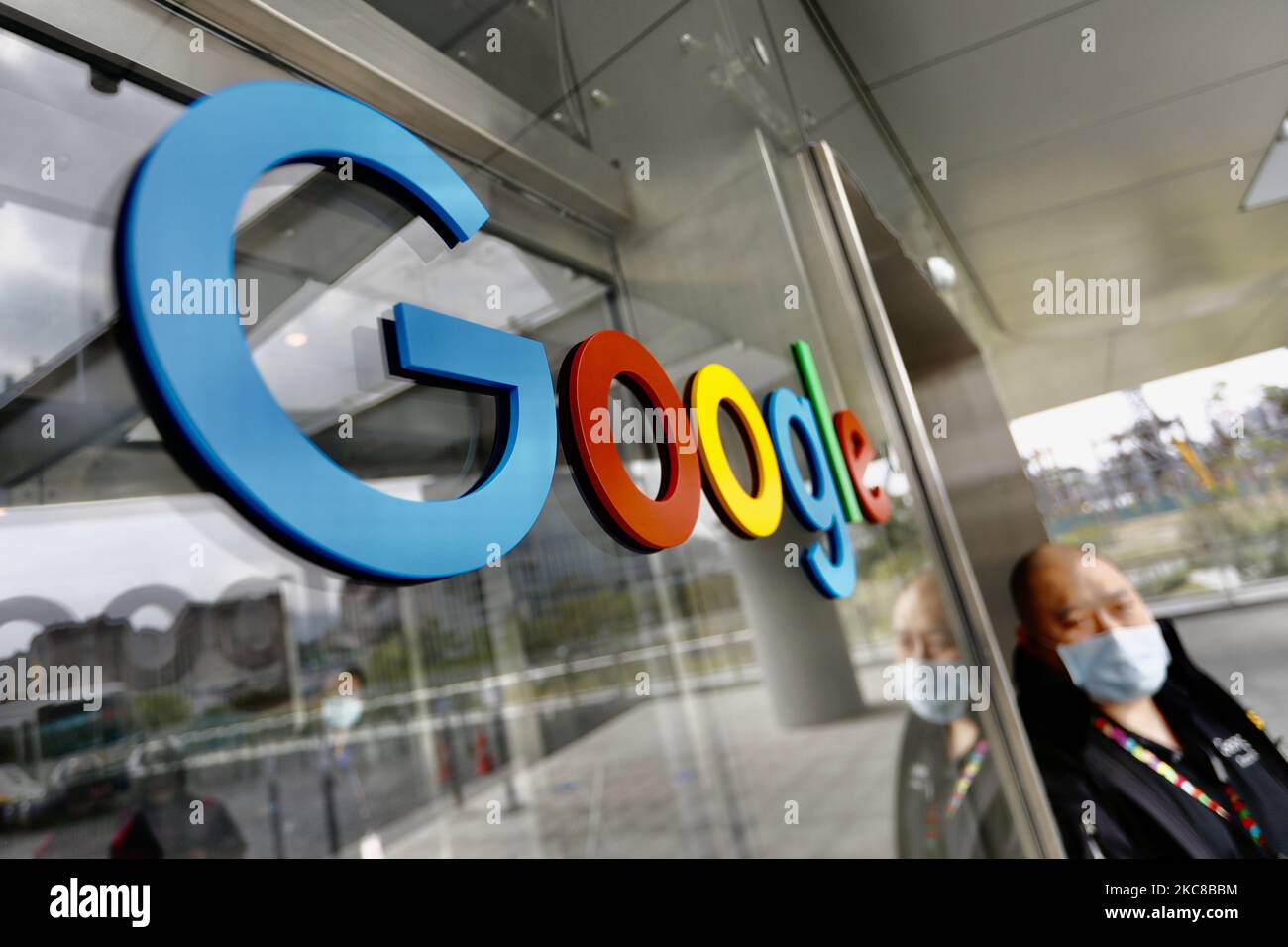 People walk out of a building where Google's new office has recently ...