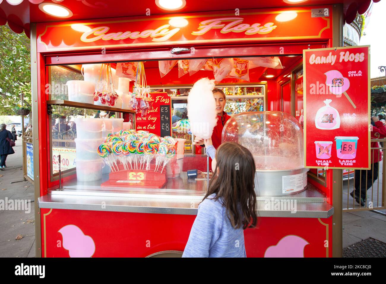 Young girl buying candy floss from street vender. London England Stock ...
