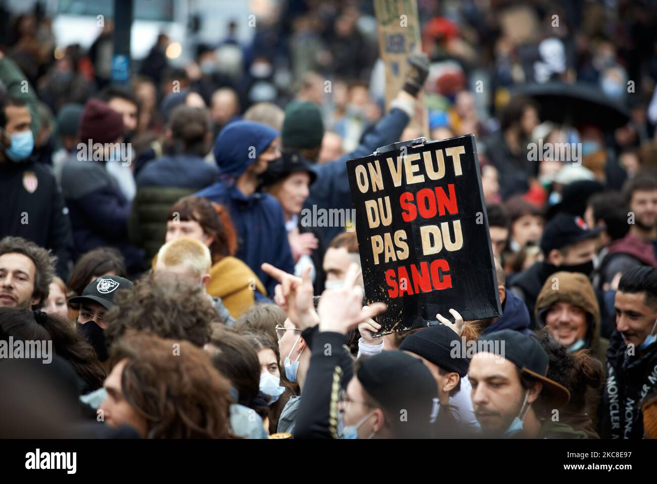 A placard in the crowd reads 'We want sound, not blood'. Nearly 10,000 ...