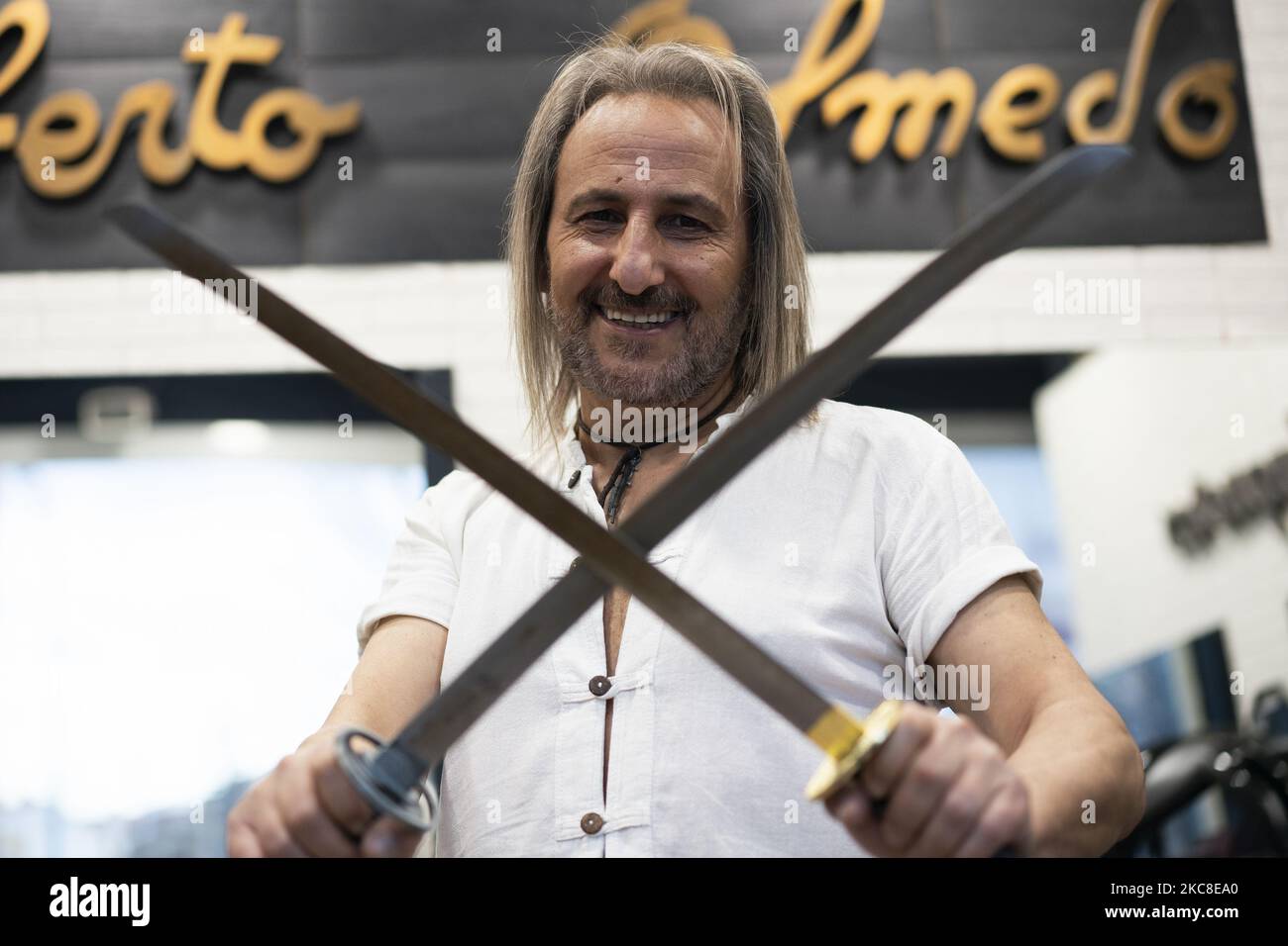 Hairdresser Alberto Olmedo demonstrates cutting a woman's hair using ...