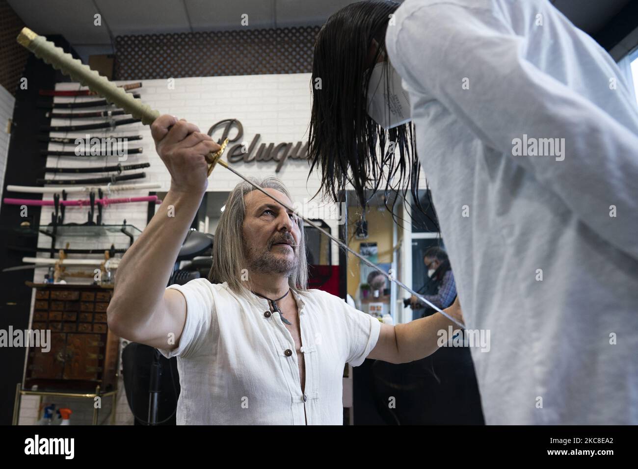 Hairdresser Alberto Olmedo demonstrates cutting a woman's hair using ...