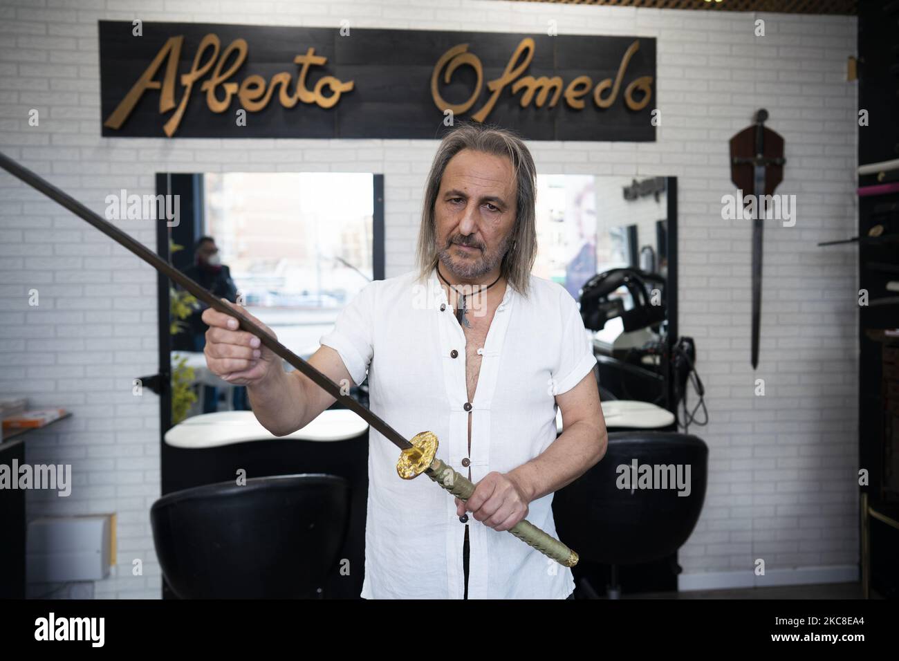 Hairdresser Alberto Olmedo demonstrates cutting a woman's hair using ...