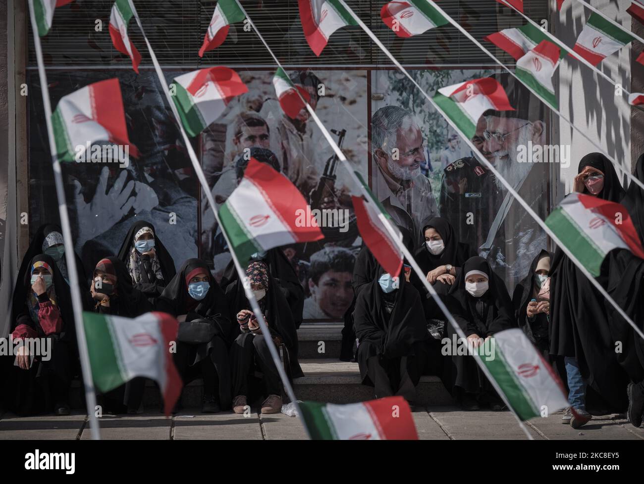 Iranian veiled women wearing protective face masks attend the first day ...