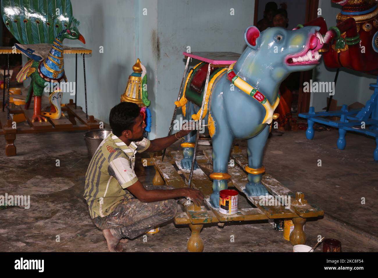 Artisan paints a large Vahana of a rat the Arasadi Vinayagar Temple ...