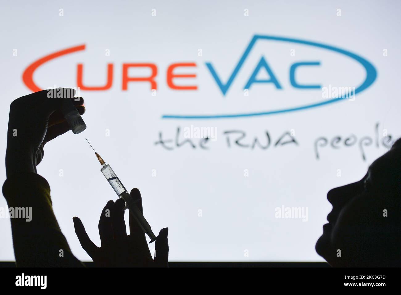 An illustrative image of a hand holding a medical syringe in front of ...