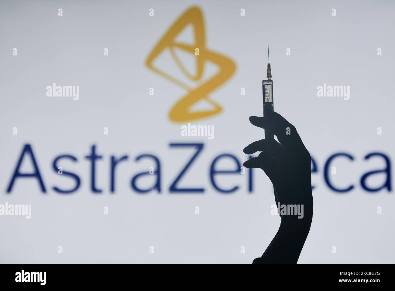 An illustrative image of a hand holding a medical syringe in front of ...