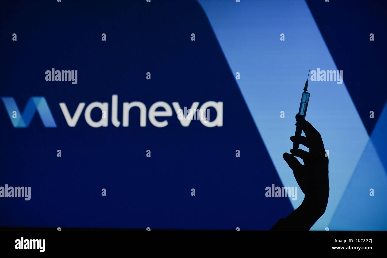 An illustrative image of a hand holding a medical syringe in front of ...