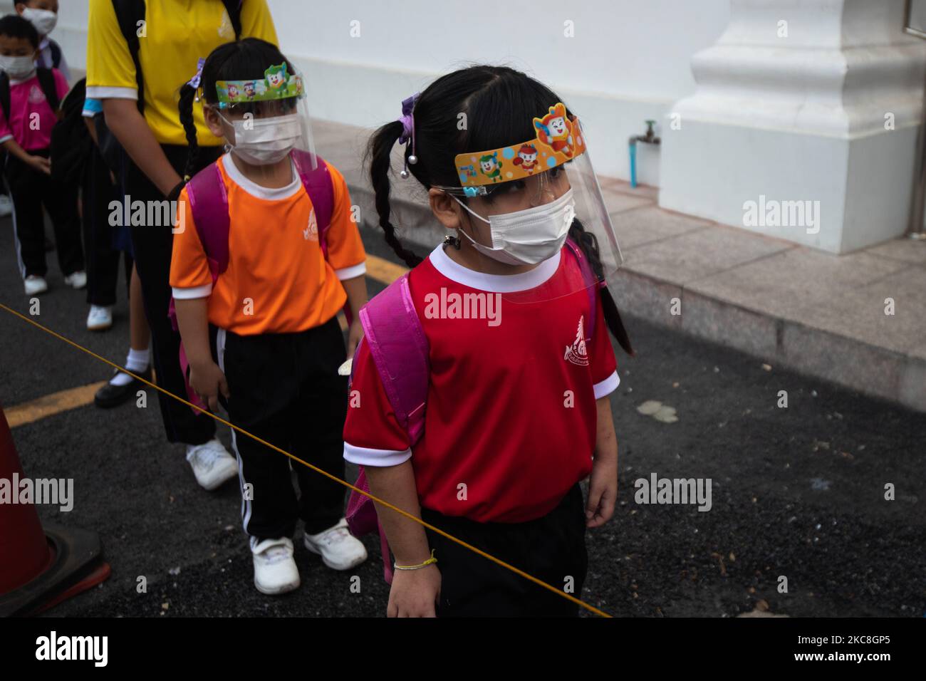 Elementary school students wearing a face shield as a preventive ...
