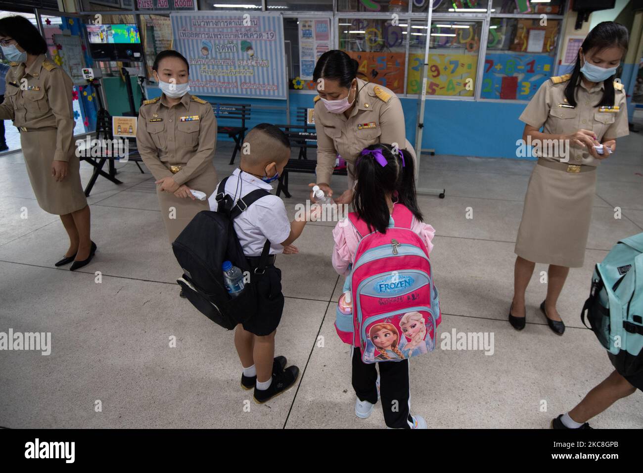 Elementary school students wearing a face mask as a preventive measure ...