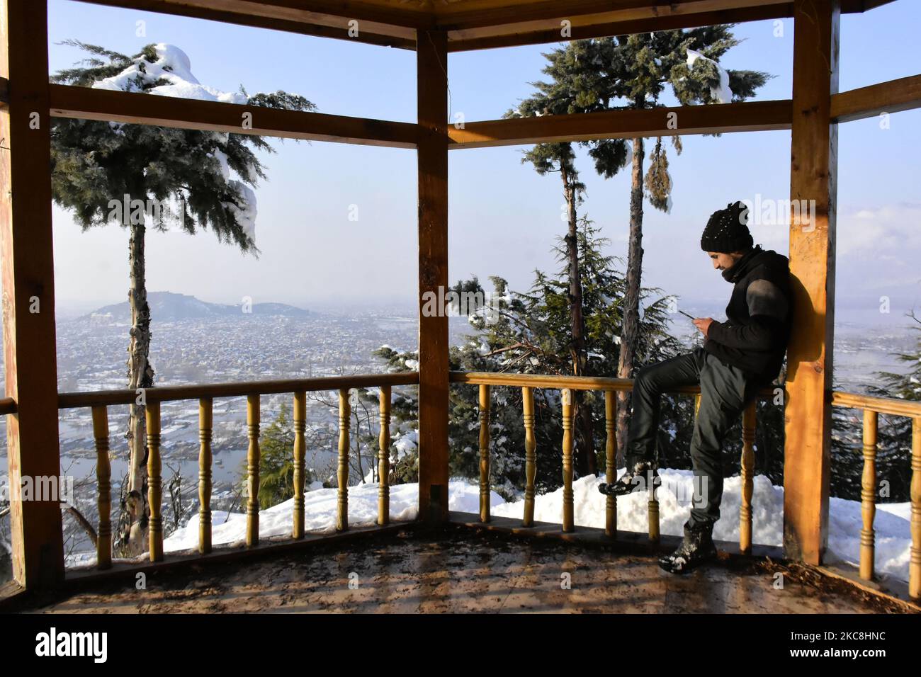 A Kashmiri boy sits inside a shelter on the foot hills of Zabarwan ...