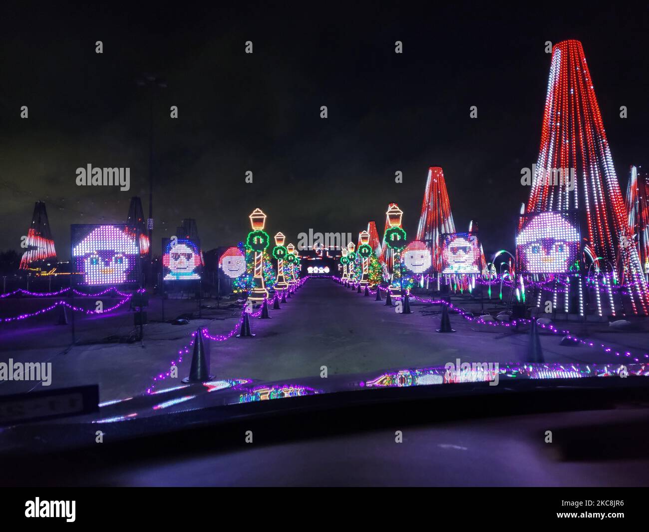 A view of an illuminated attraction park with colorful lights at night ...