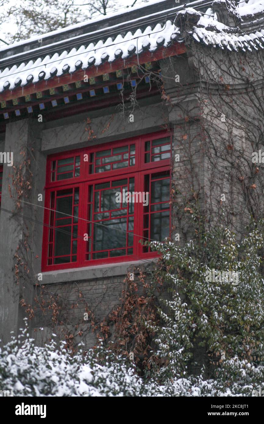 A vertical shot of beautiful traditional red windows on the facade of a ...
