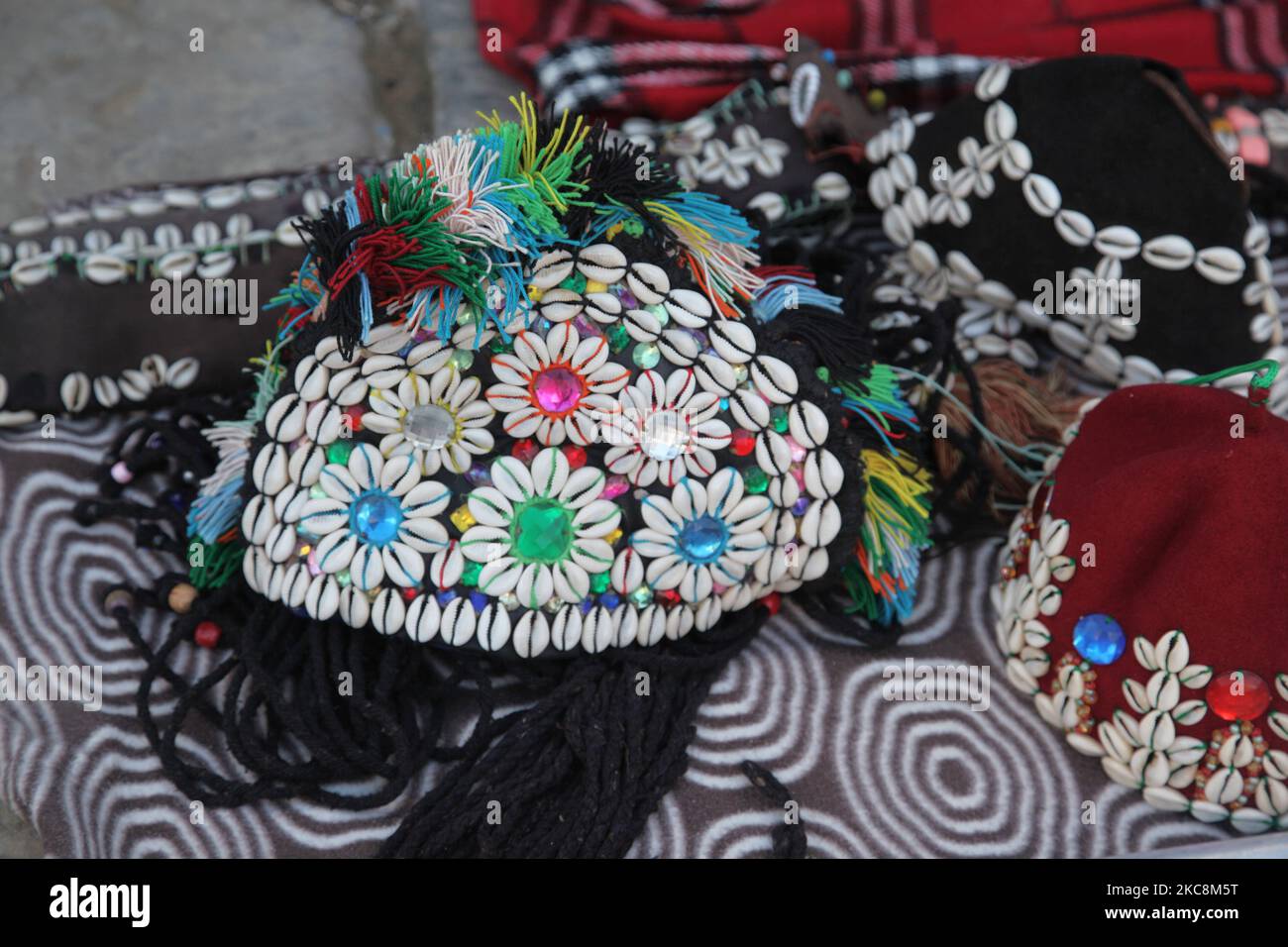 Traditional African hats decorated with cowrie seashells in the town of ...