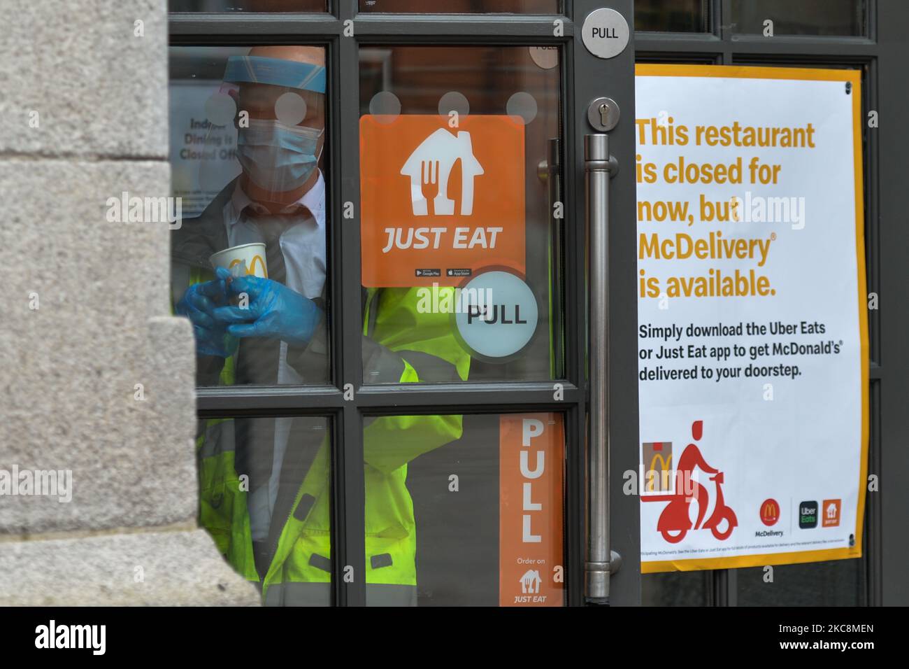 A security man wearing a face mask seen at McDonald's entrance in ...