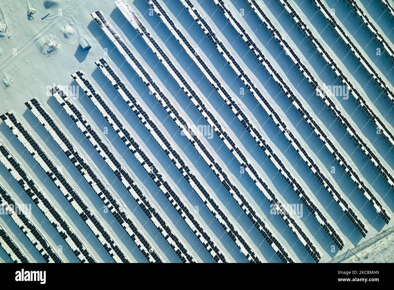 Aerial view of snow melting from covered solar photovoltaic panels at ...