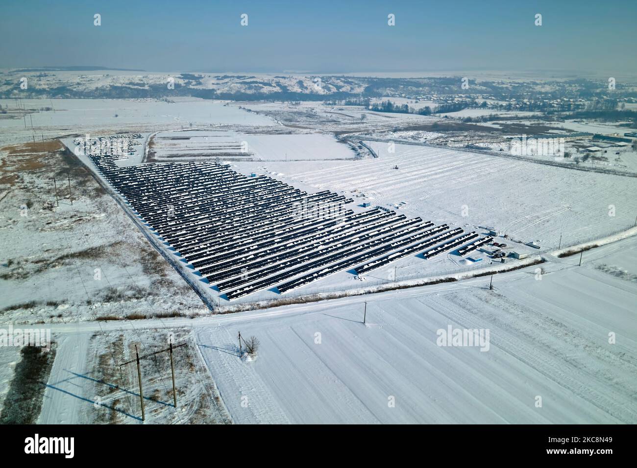 Aerial view of snow melting from covered solar photovoltaic panels at ...