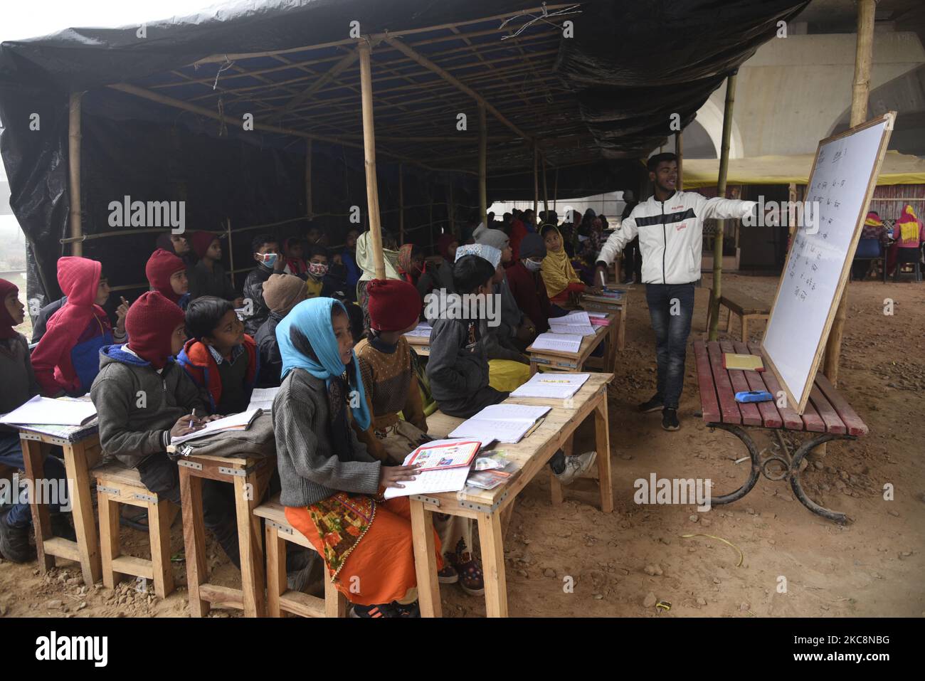 Underprivileged children study at an improvised classroom set up under ...