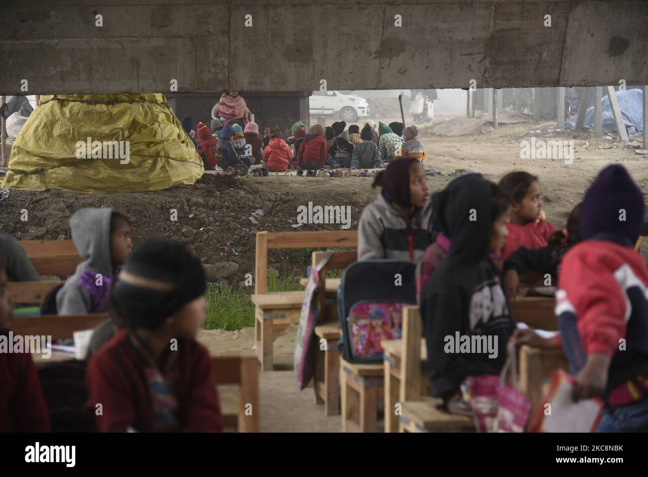Underprivileged children study at an improvised classroom set up under ...