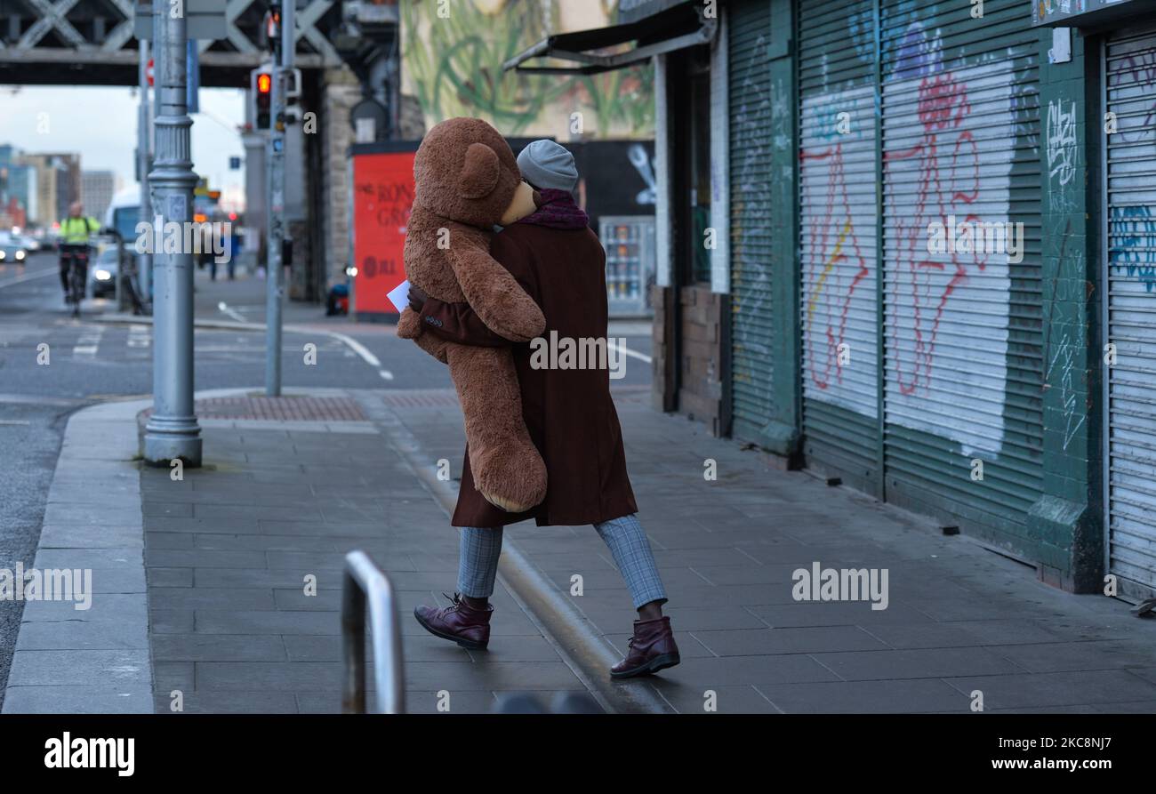 A person carrying a large teddy bear in Dublin city center during Level ...
