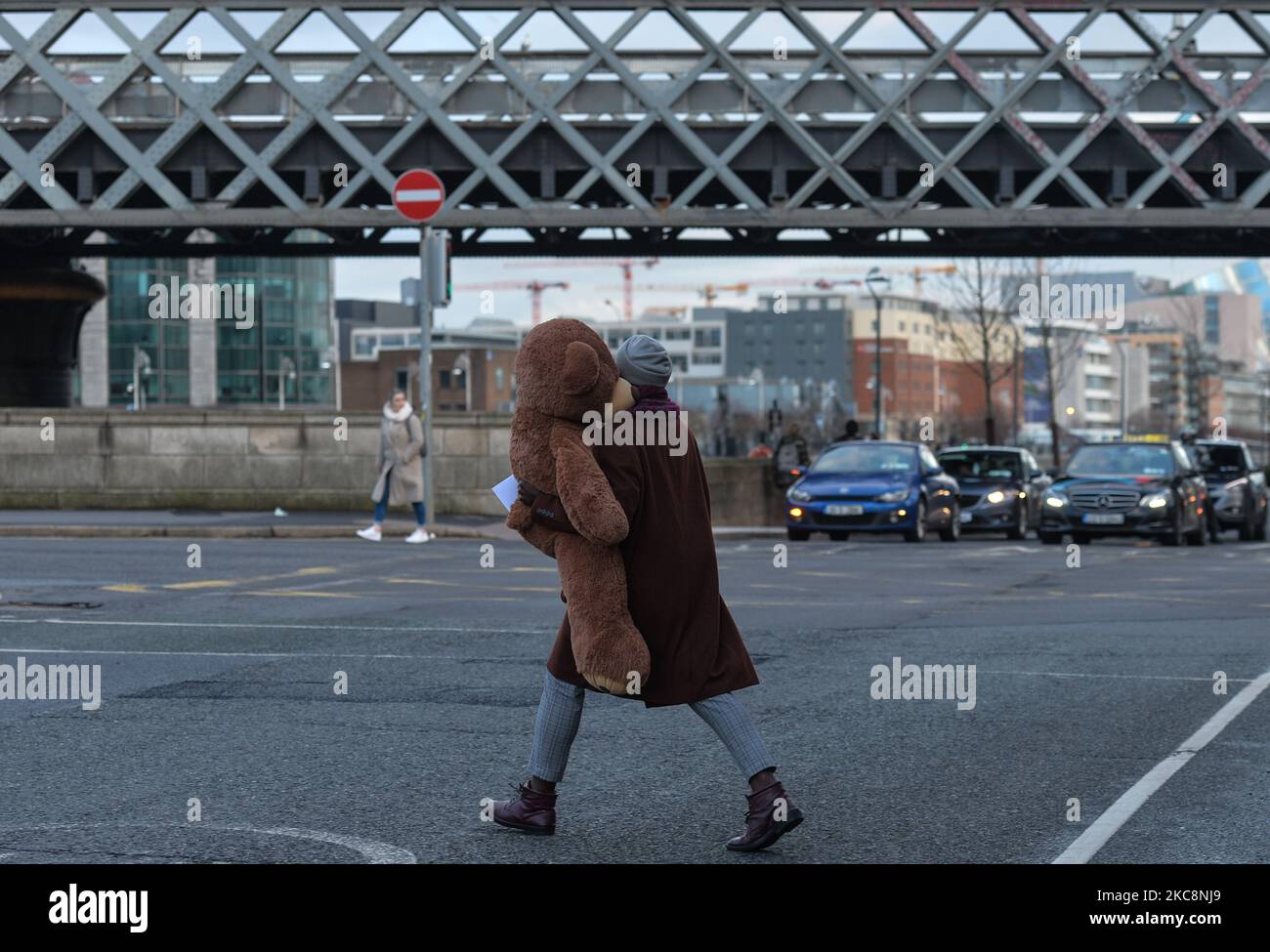 A person carrying a large teddy bear in Dublin city center during Level ...