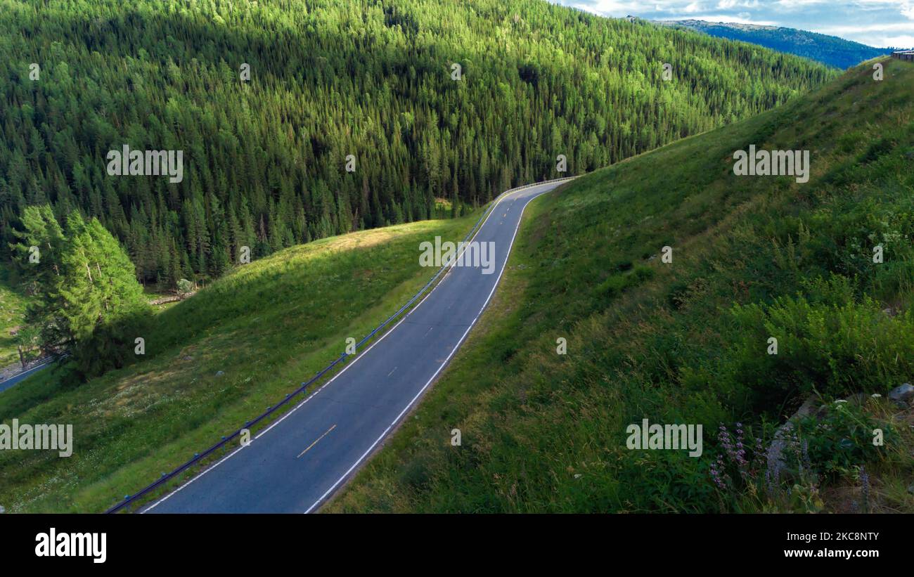 The road built on a mountain, past the forest Stock Photo - Alamy