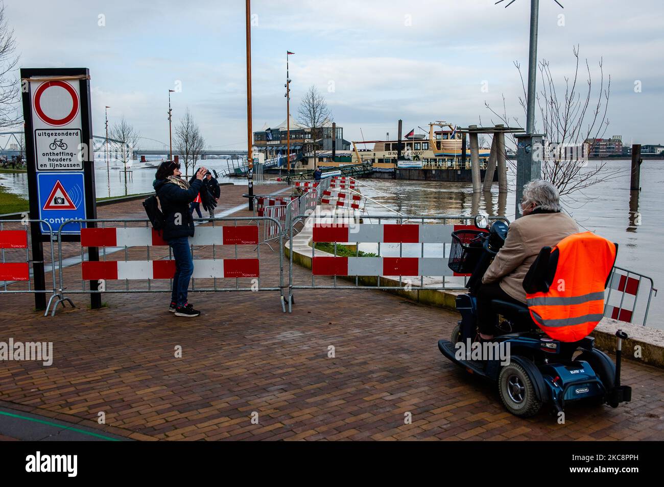 People are watching the Waal river flooding, during the high water ...