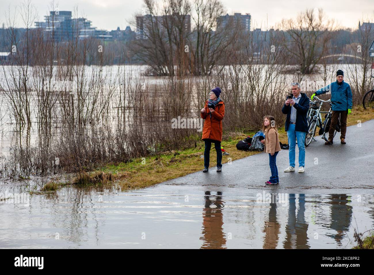 People are watching the Waal river flooding, during the high water ...