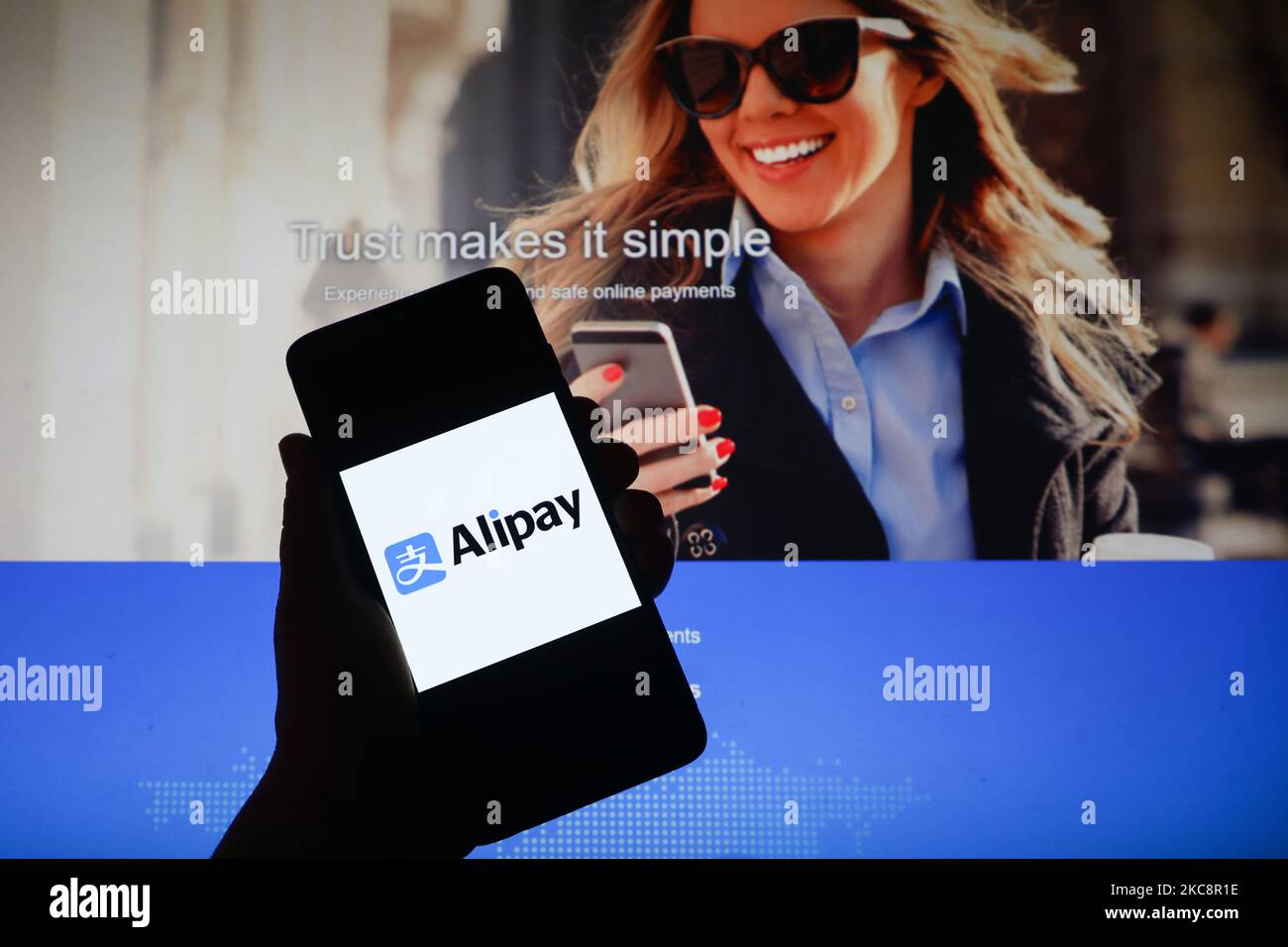 Alipay app logo is displayed on a mobile phone screen with Alipay ...