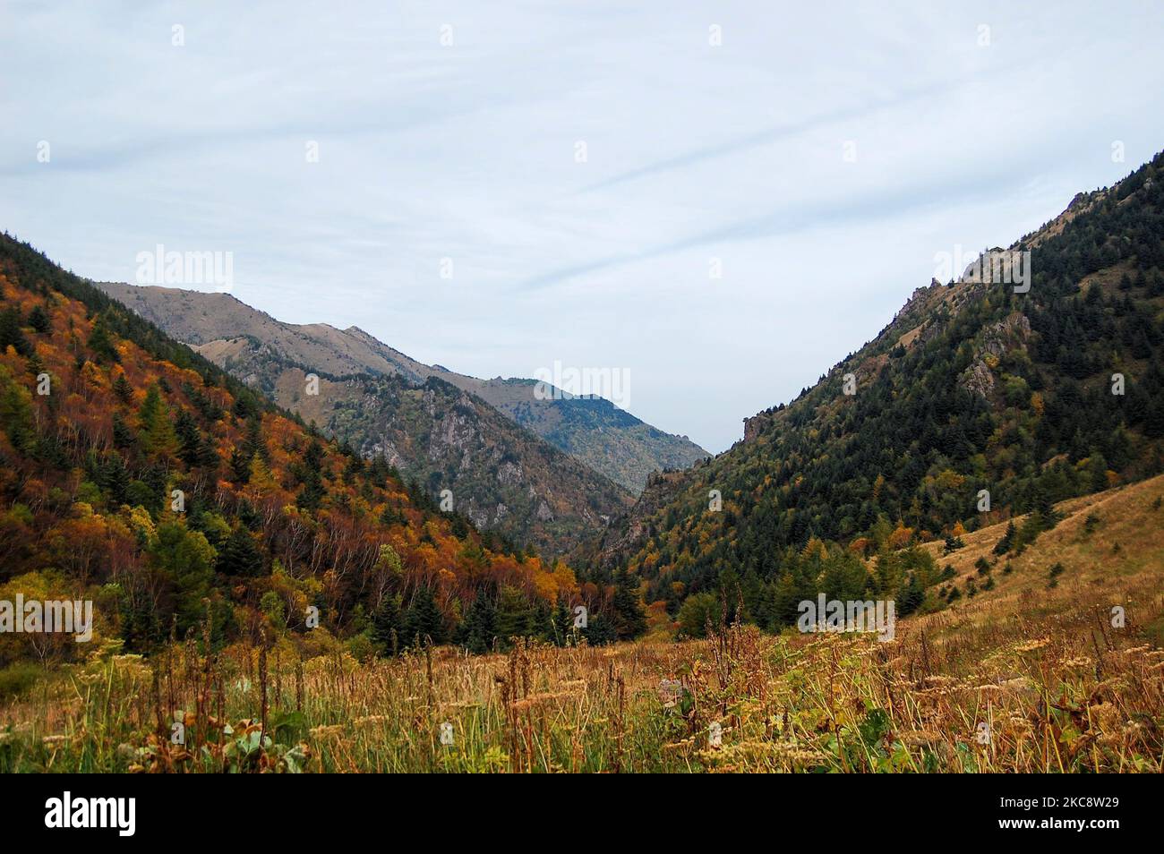 A view of the mountains and the cloudy sky Stock Photo - Alamy